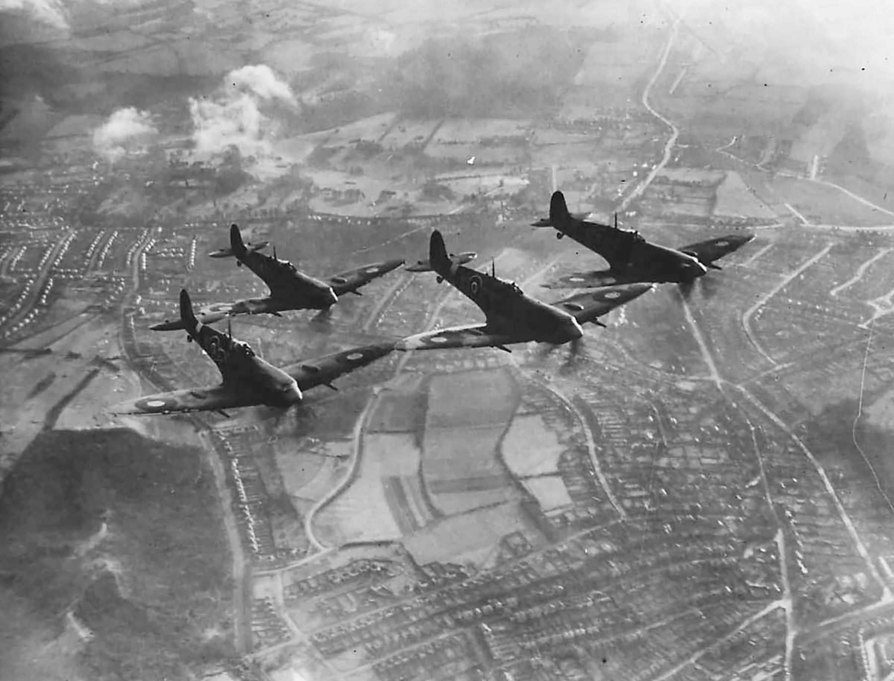 Asisbiz Spitfires over England in tight formation 1942-web 01
